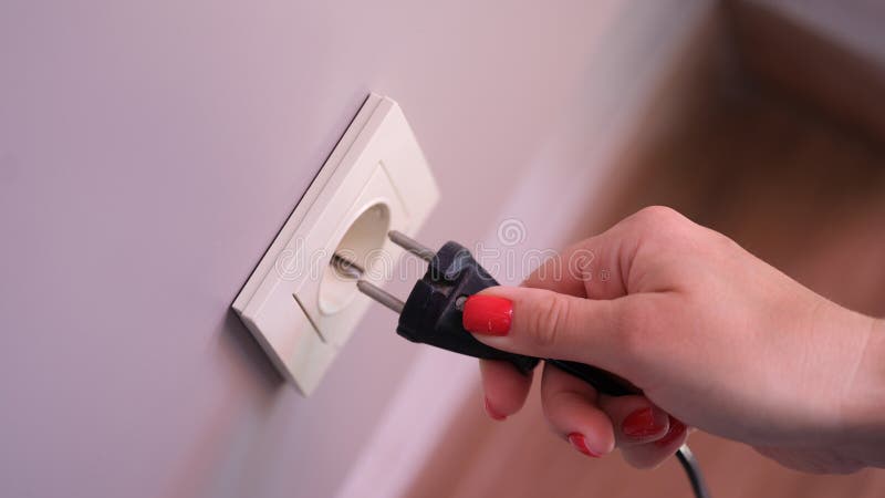 Hand Inserts Plug into Socket Closeup. Use of Promising Energy in Home ...