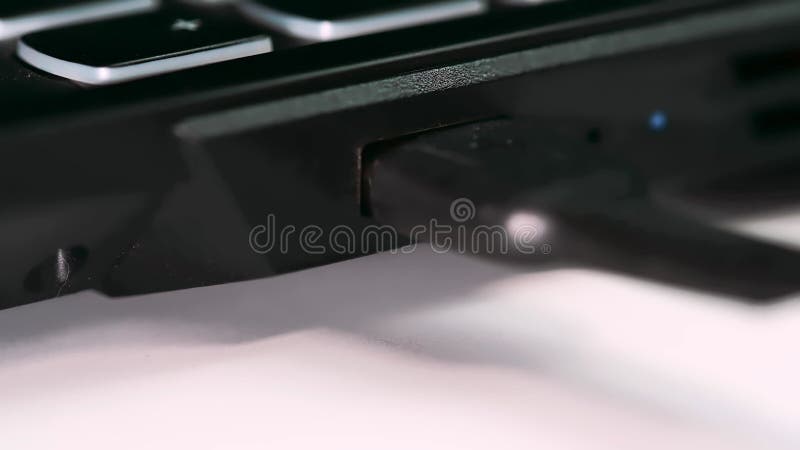A Hand Inserts a Usb Cable with a Connector into a Black Laptop. Close ...