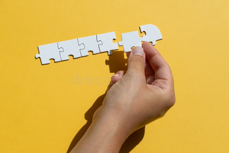 Hand Join the Piece of Jigsaw Puzzle To Complete the Line. Stock Photo ...