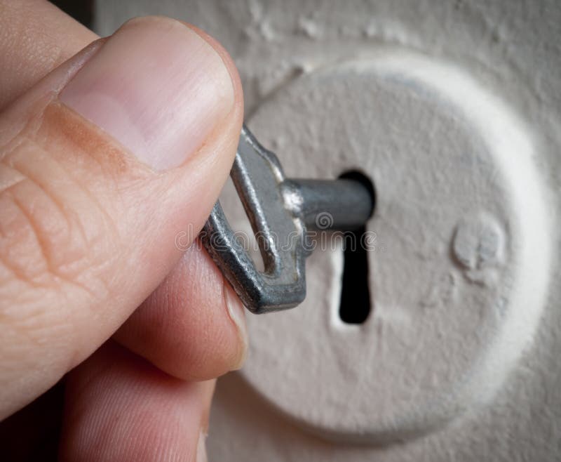 Hand with key in keyhole. stock image. Image of finger - 31108241