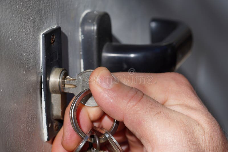 Hand with Keys Inserting into Lock Stock Photo - Image of limb, knob ...