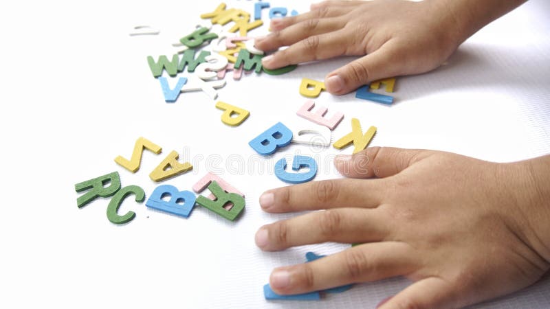 Hand of a Kid Playing with Colorful Alphabets Stock Photo - Image of ...