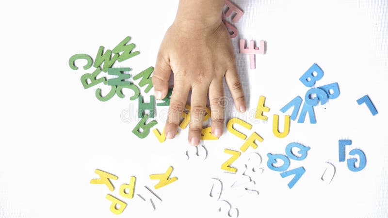 Hand of a Kid Playing with Colorful Alphabets Stock Photo - Image of ...