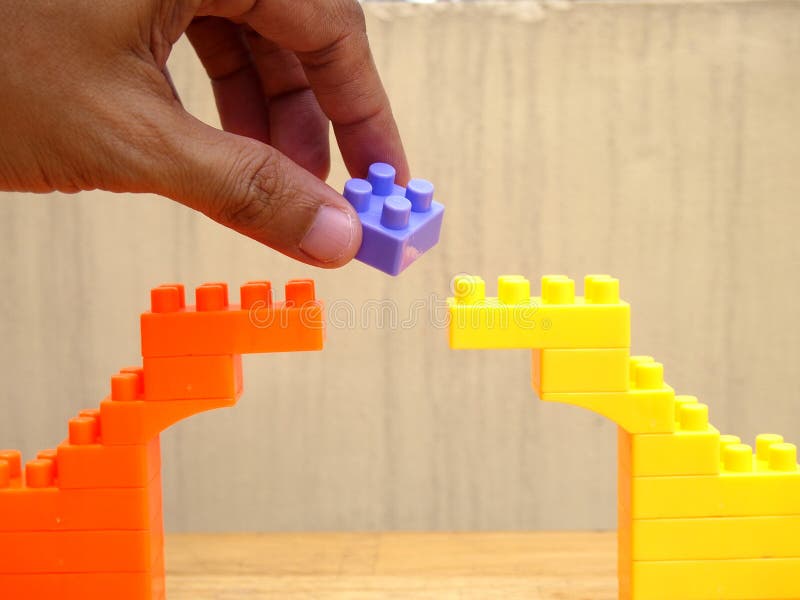 Hand Lifting Block from Bridge Made of Toy Blocks Stock Photo - Image ...
