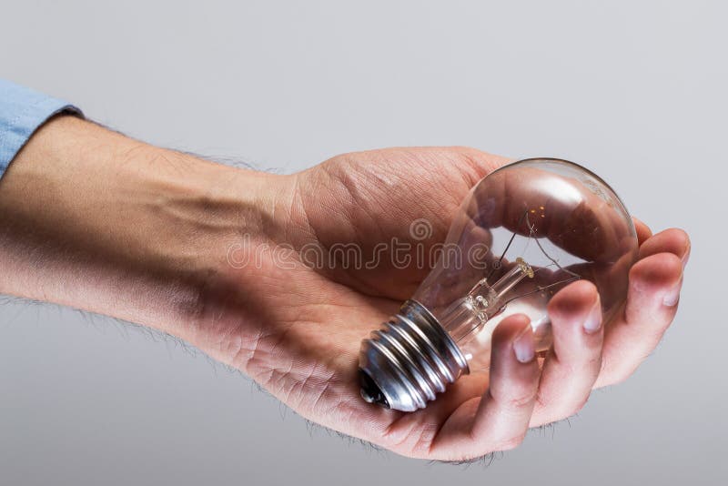Hand with light bulb stock photo. Image of environment - 56372660