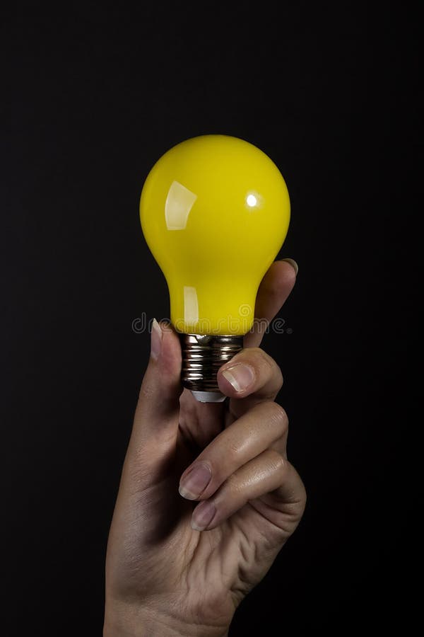 Hand with light bulb stock photo. Image of holding, yellow - 154650470