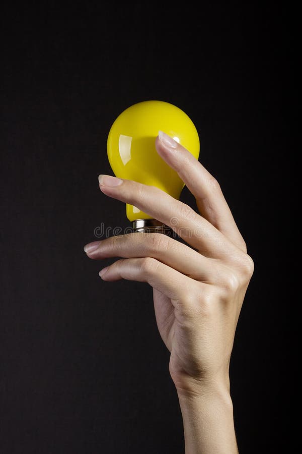Hand with light bulb stock photo. Image of conservation - 154999454
