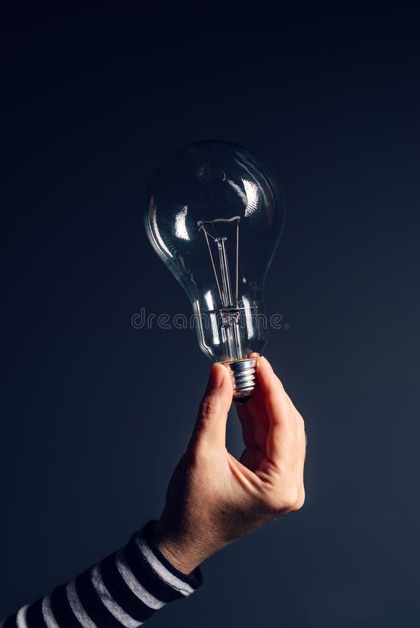 Hand with light bulb stock photo. Image of inspiration - 85237842