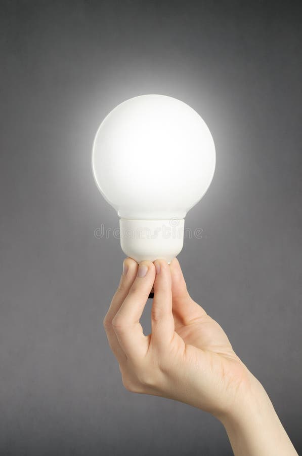 Hand with light bulb stock photo. Image of industry, consumption - 65104240