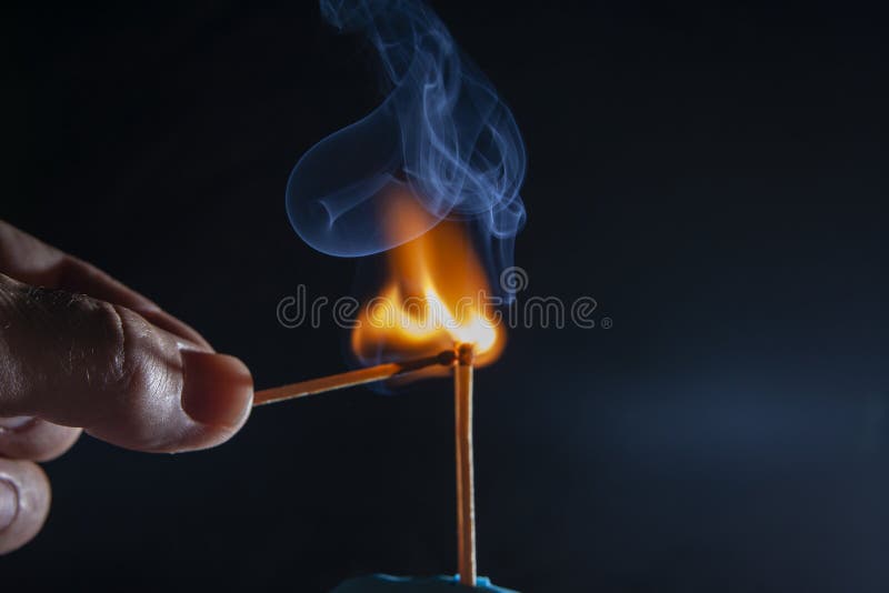 A Hand with a Lit Match Lighting Another Match Stock Photo - Image of ...