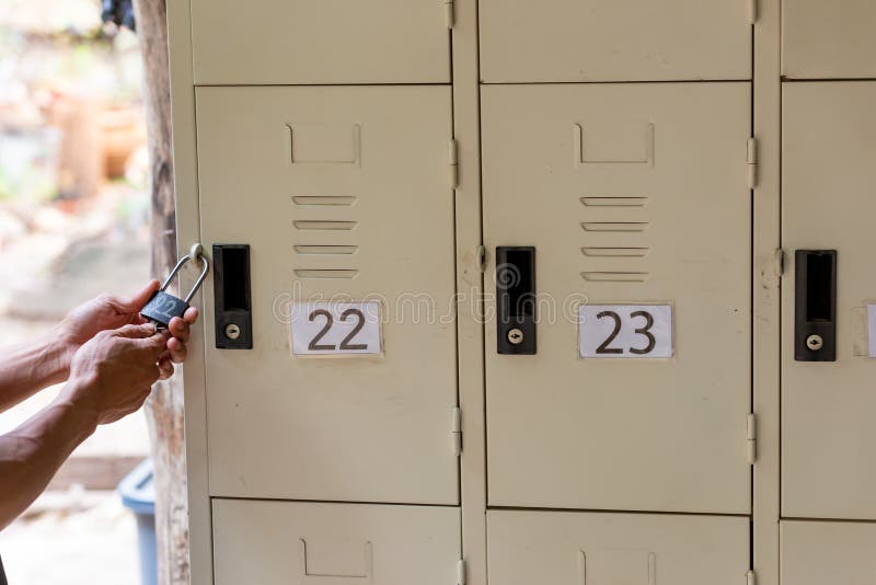 A Hand with a Locker Key Numbered Lockers for Safety Stock Image ...