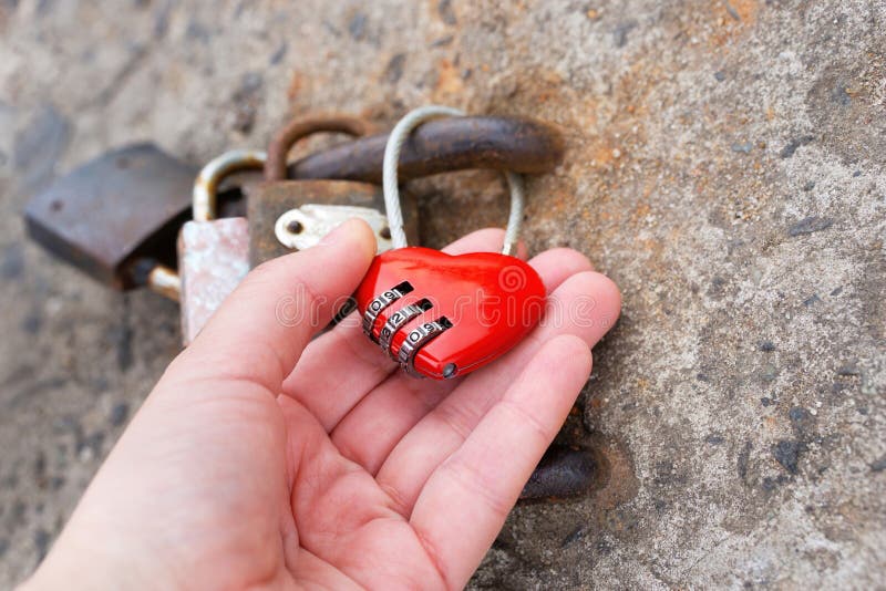 Hand Locking a Heart Shaped Padlock Stock Photo - Image of combination ...