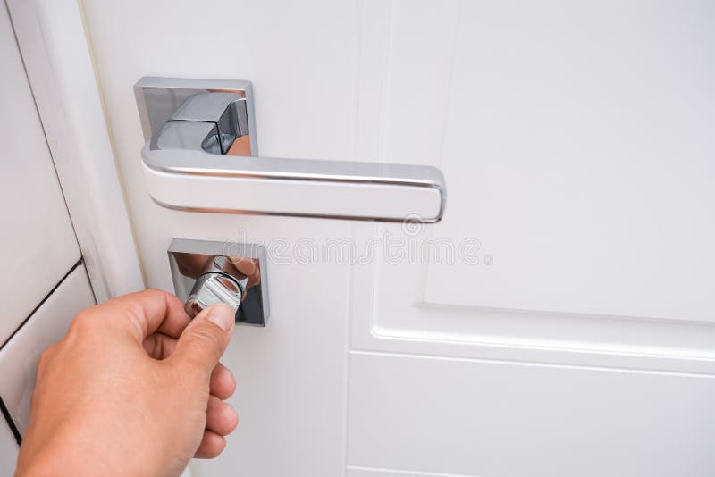 Hand Locking a White Door Using a Knob for Safety and Privacy, Home ...