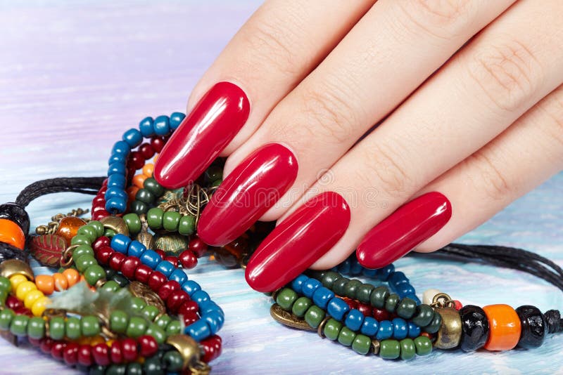 Hand with Long Artificial Manicured Nails Colored with Red Nail Polish ...