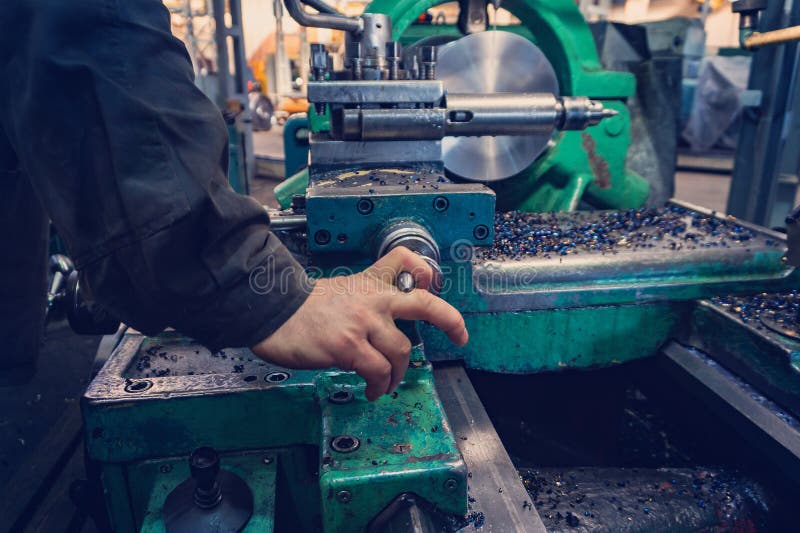 The Hand of the Machine Operator Creates a Mechanical Switch on the ...