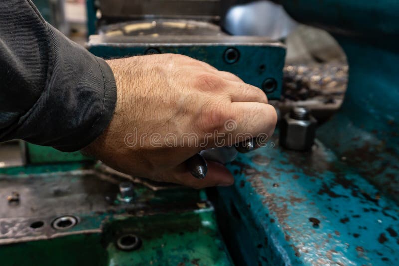 The Hand of the Machine Operator Creates a Mechanical Switch on the ...