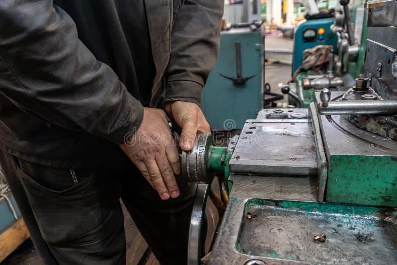 The Hand of the Machine Operator Creates a Mechanical Switch on the ...