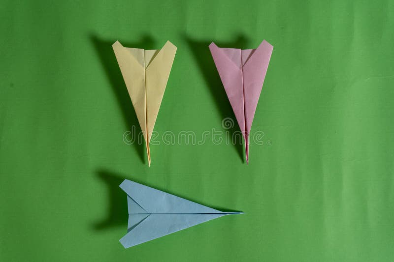 Hand-made Paper Airplanes in Different Colors on a Green Surface Stock ...
