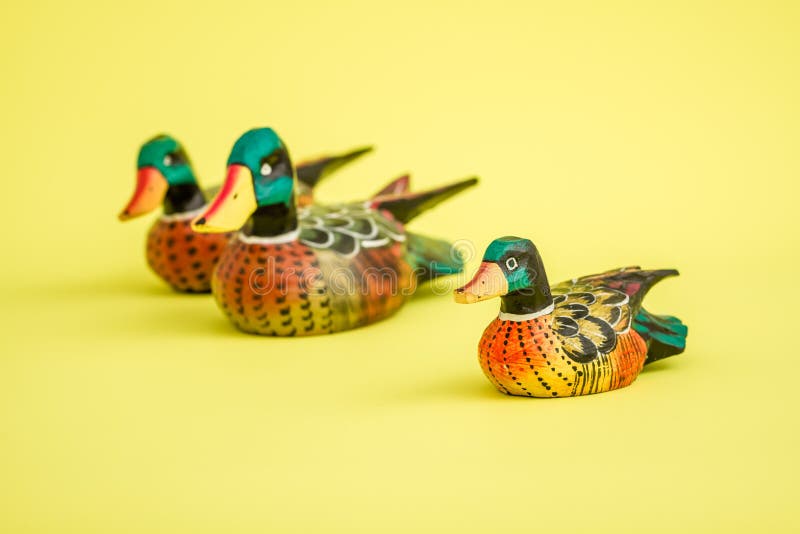 Hand Made Wooden Ducks for Home Decoration on Yellow Background Stock ...