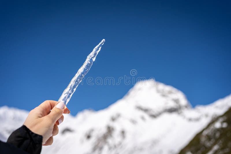 Hand with the Magic Wand of Ice, Icicle, Mountains, Blue Sky Stock ...