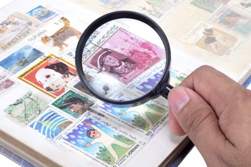 Hand with Magnifying Glass and Stamp Album Editorial Stock Image ...