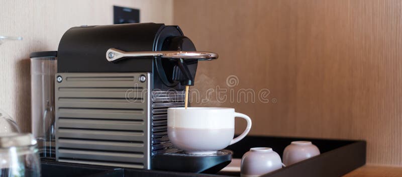 Hand Making Espresso by Coffee Machine with Capsules on Wood Table ...
