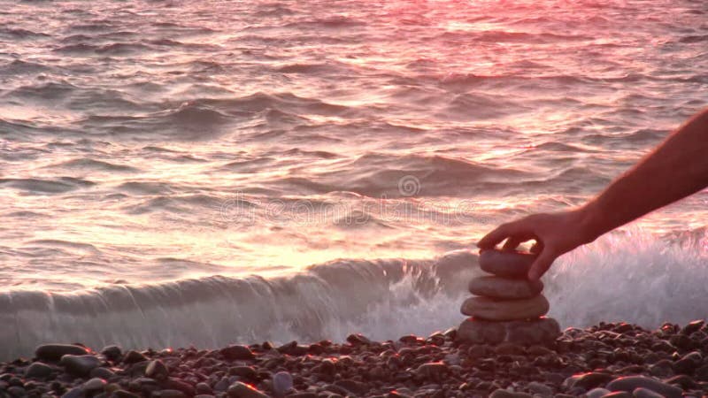 Hand Making Pyramid from Stones Pebble on Stock Footage - Video of ...