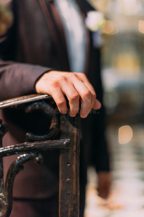 The Hand of the Man on the Black Iron Stair Railing. Stock Photo ...