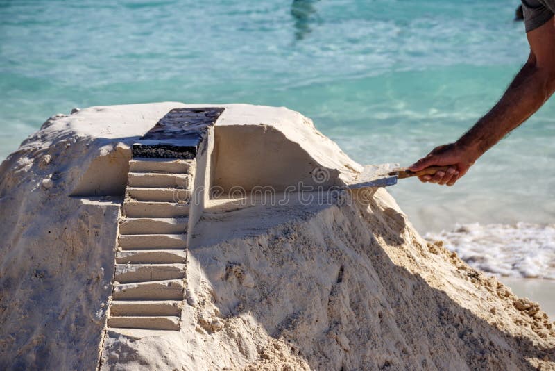 Hand of a Man Building a Pyramid of Sand on the Sea Shore Stock Photo ...