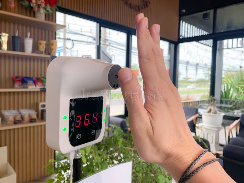 Hand of Man Checking Temperature before Entering Cafe with Digital ...