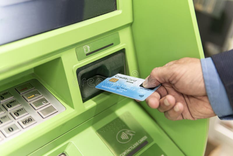 Hand of Man with a Credit Card, Using an ATM. Man Using an Atm Machine ...