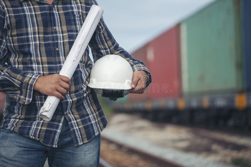 Hand of Man Engineer Holding Safety Hat and Blue Print and Inspect in ...
