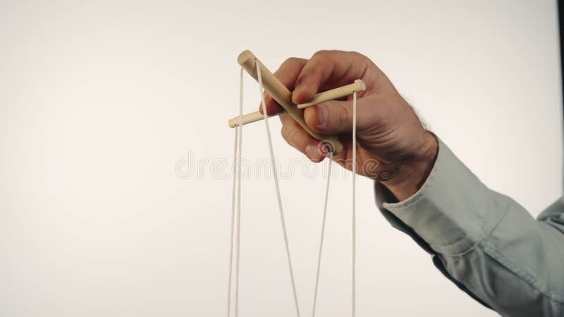 The Hand of a Man in a Gray Shirt Controls a Puppet Using a Wooden ...