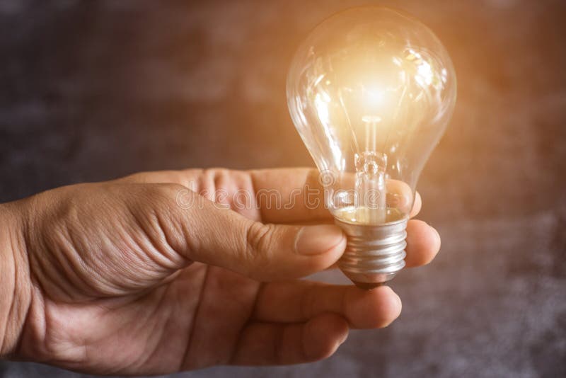 Hand of Man Holding Illuminated Light Bulb, Idea, Concept Creativity ...