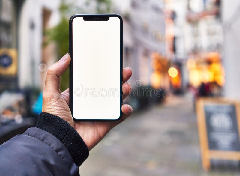 Hand of Man Holding Smartphone at Street Stock Image - Image of road ...
