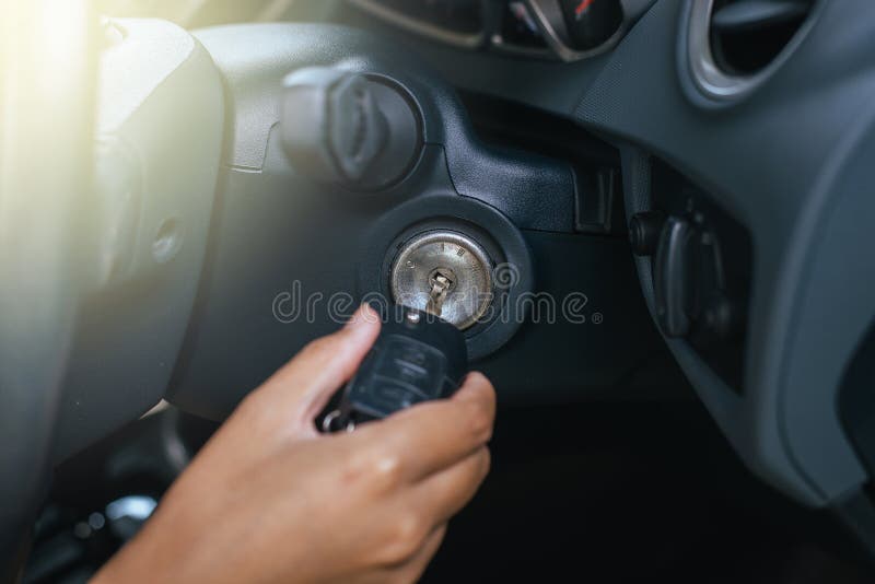 Hand of Man Inserting Key To Start Car System,Button on Dashboard in ...