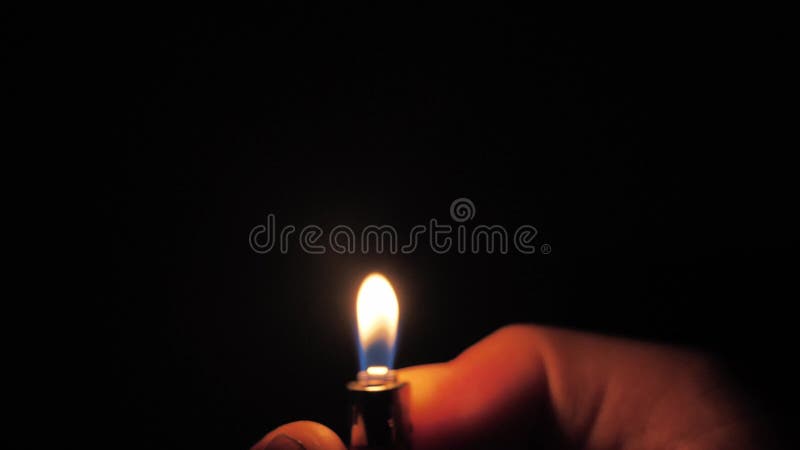 Hand of a Man Lighting a Lighter in a Dark Room. Light, Fire Stock ...