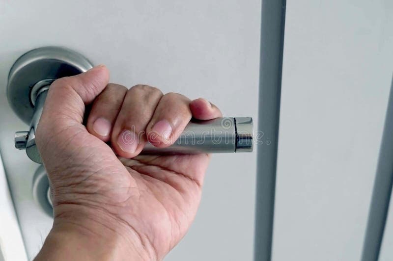 Hand of a Man Opens the Door Handle with a Key in the Lock Stock Image ...