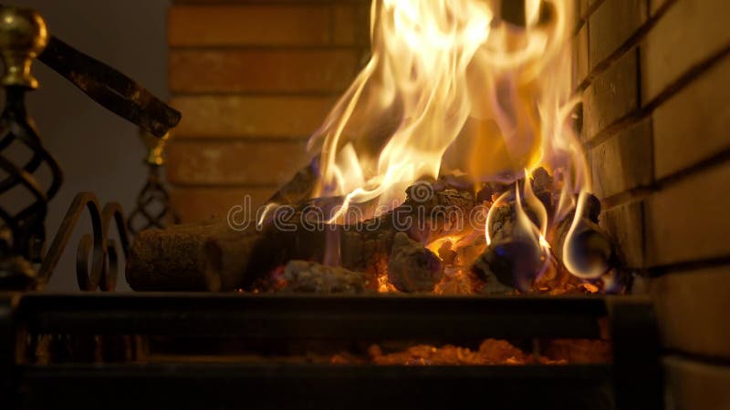 Hand of Man Placing the Lit Logs in the Fireplace To Keep the Heat of ...