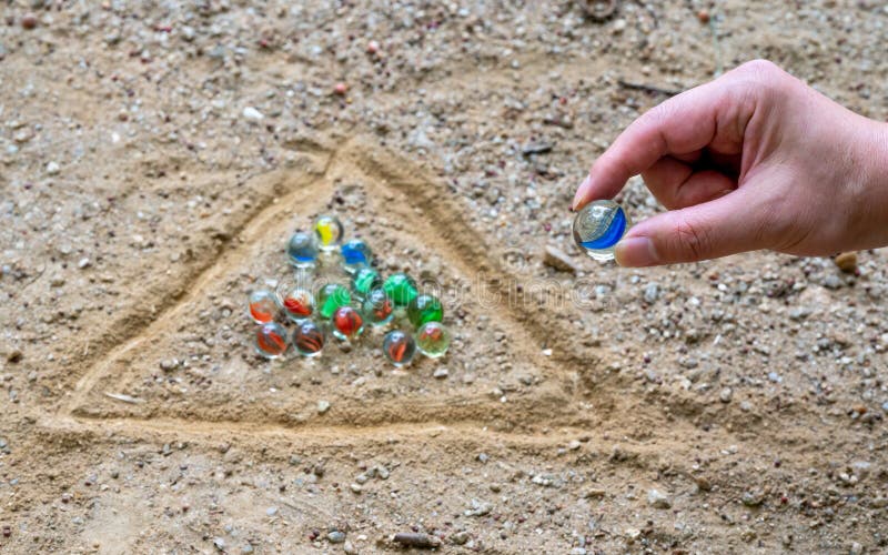 The Hand of a Man Playing Marbles in a Playground with Dirt Stock Image ...