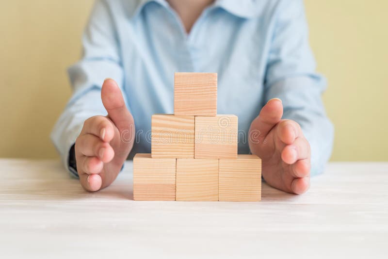 Hand of a Man Protecting Wood Blocks Group Stock Photo - Image of hand ...