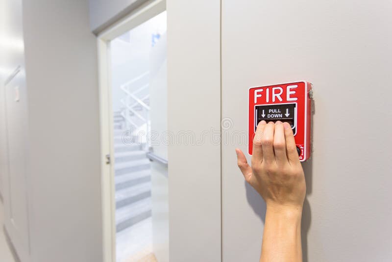 The Hand of Man is Pulling Fire Alarm on the Wall Next To the Do Stock ...