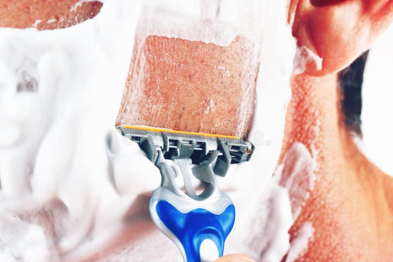 Hand Man with Razor Shaving His Face Close Up, Gently Toned Stock Photo ...