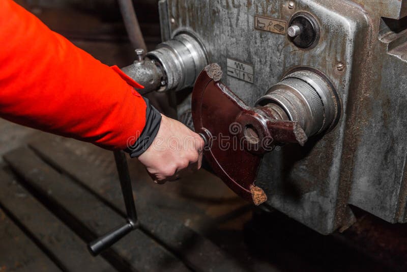 The Hand of a Man in a Red Work Suit, Holds on To the Handle and ...