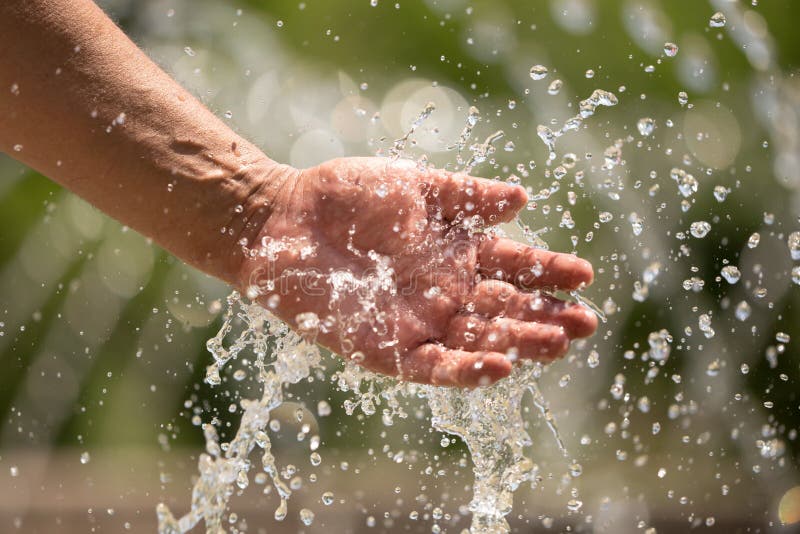 Hand of a Man in a Spray of Water from a Fountain Stock Image - Image ...