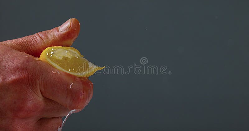 Hand of Man Squeezing Lemon, Citrus Limonum Against Black Background ...