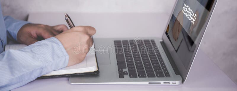 Hand of Man Watching Webinar on Laptop Computer and Writing on Notebook ...