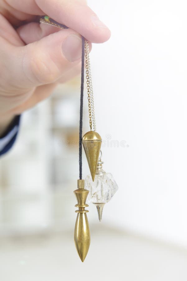 Hand with many pendulums stock photo. Image of metal - 188844776