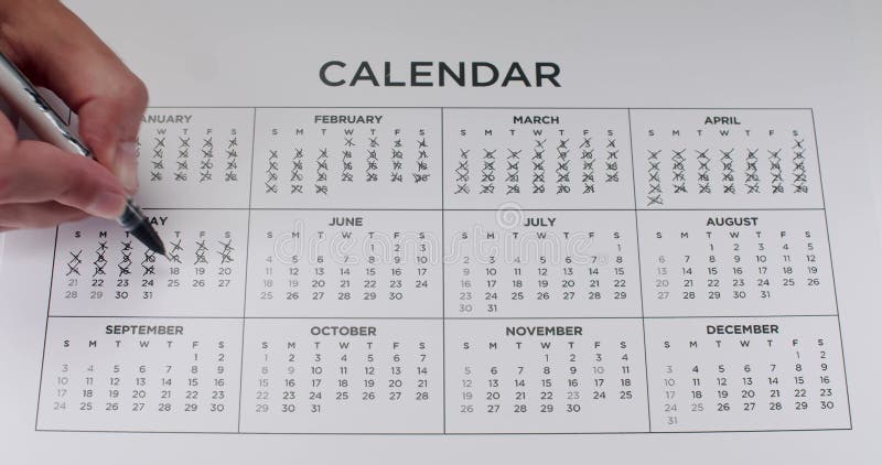 Hand Marking Days Off on Calendar, Tracking Progress and Passage of ...