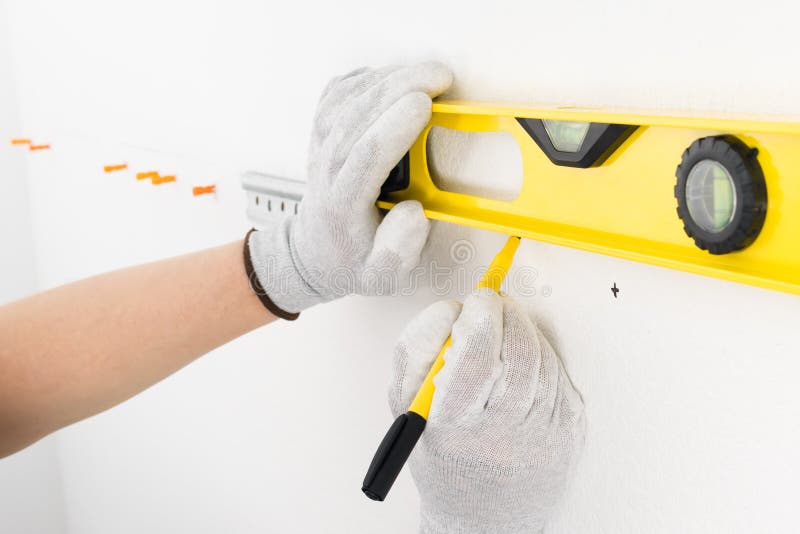 The Hand of the Master Holds the Level Tool and Draws a Straight Line ...